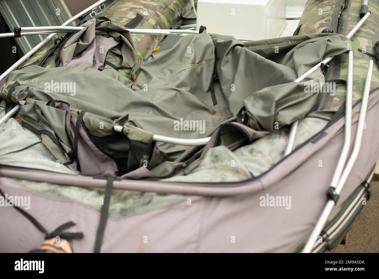 Powerboat in garage. Inflatable boat in parking lot. Storage of water ...