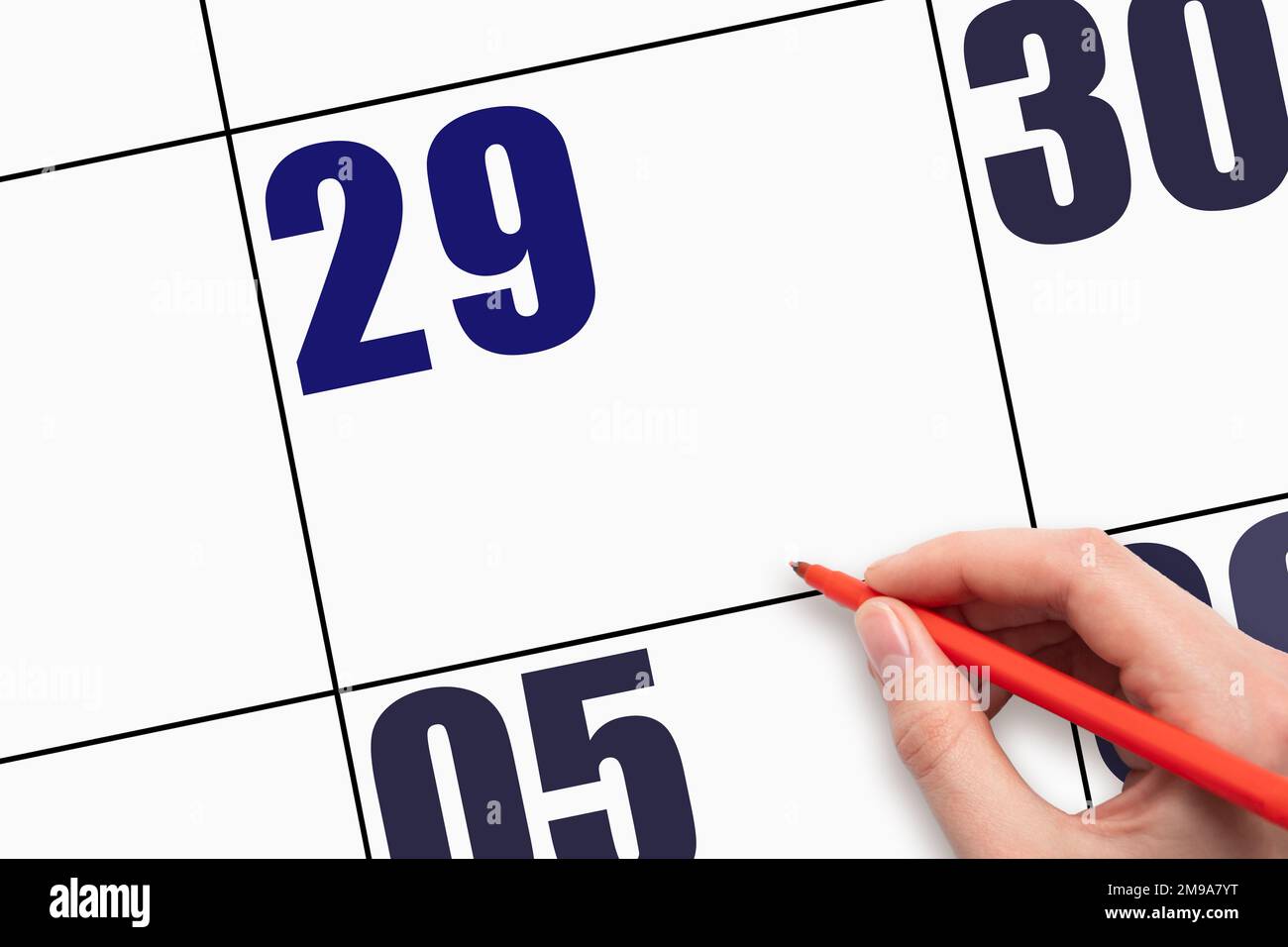 29th day of the month. Hand holding the red pen points to an empty ...