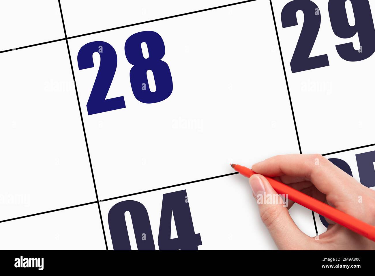 28th day of the month. Hand holding the red pen points to an empty ...