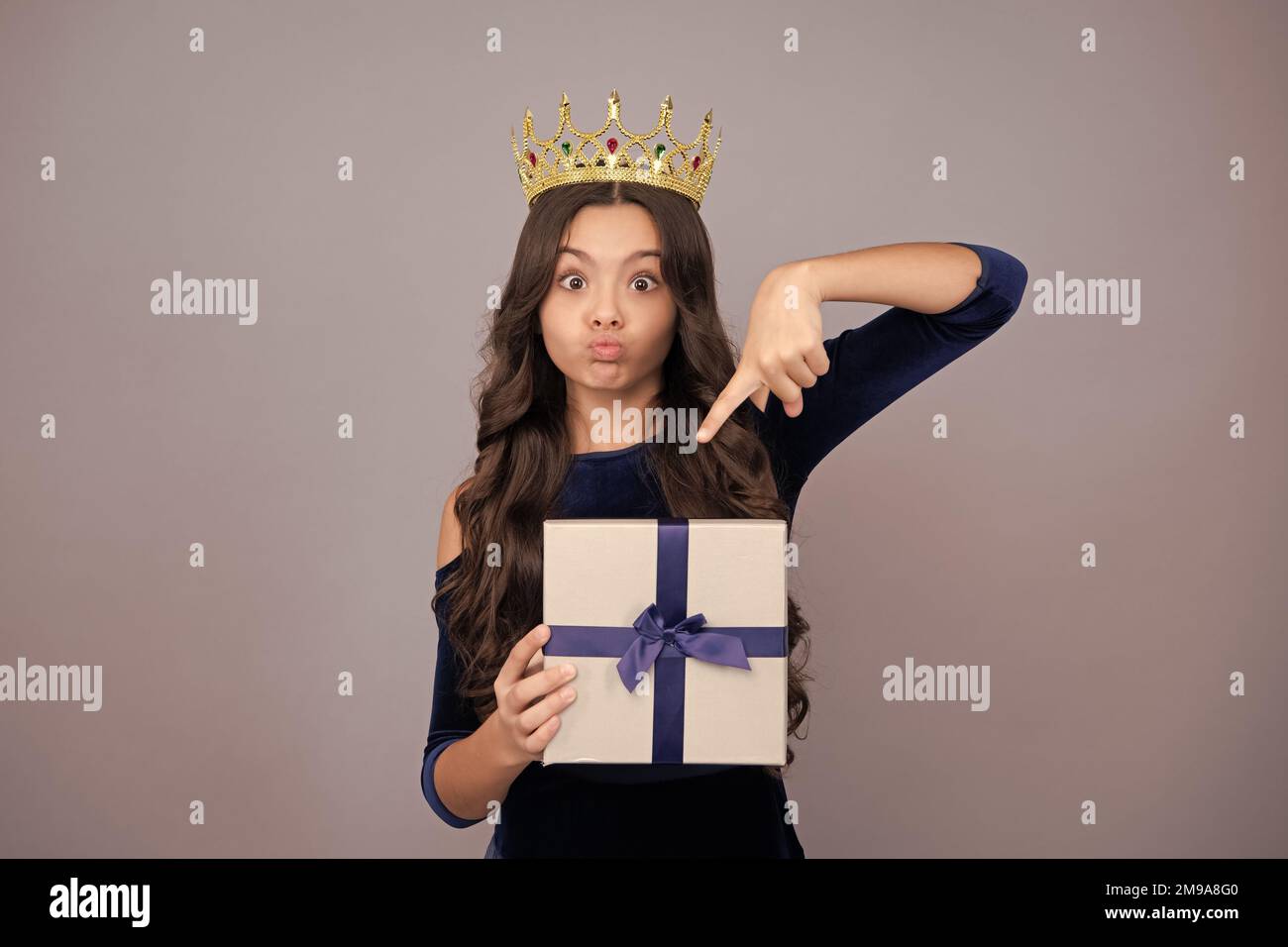 Teenager kid princess in crown with present box. Teen girl giving ...