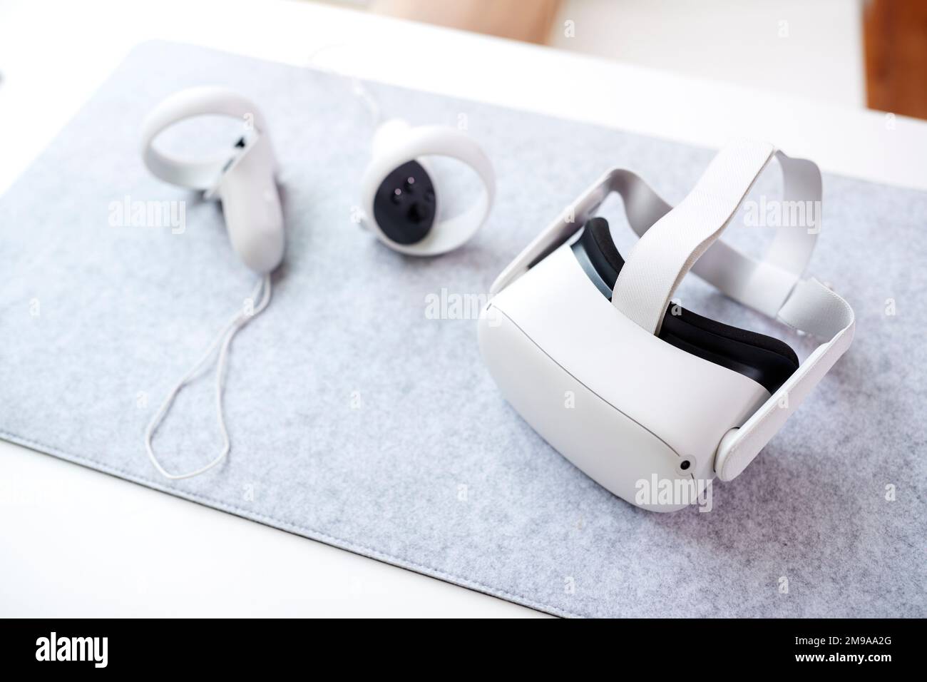 VR Headset And Gaming Controllers On Table At Home Stock Photo - Alamy