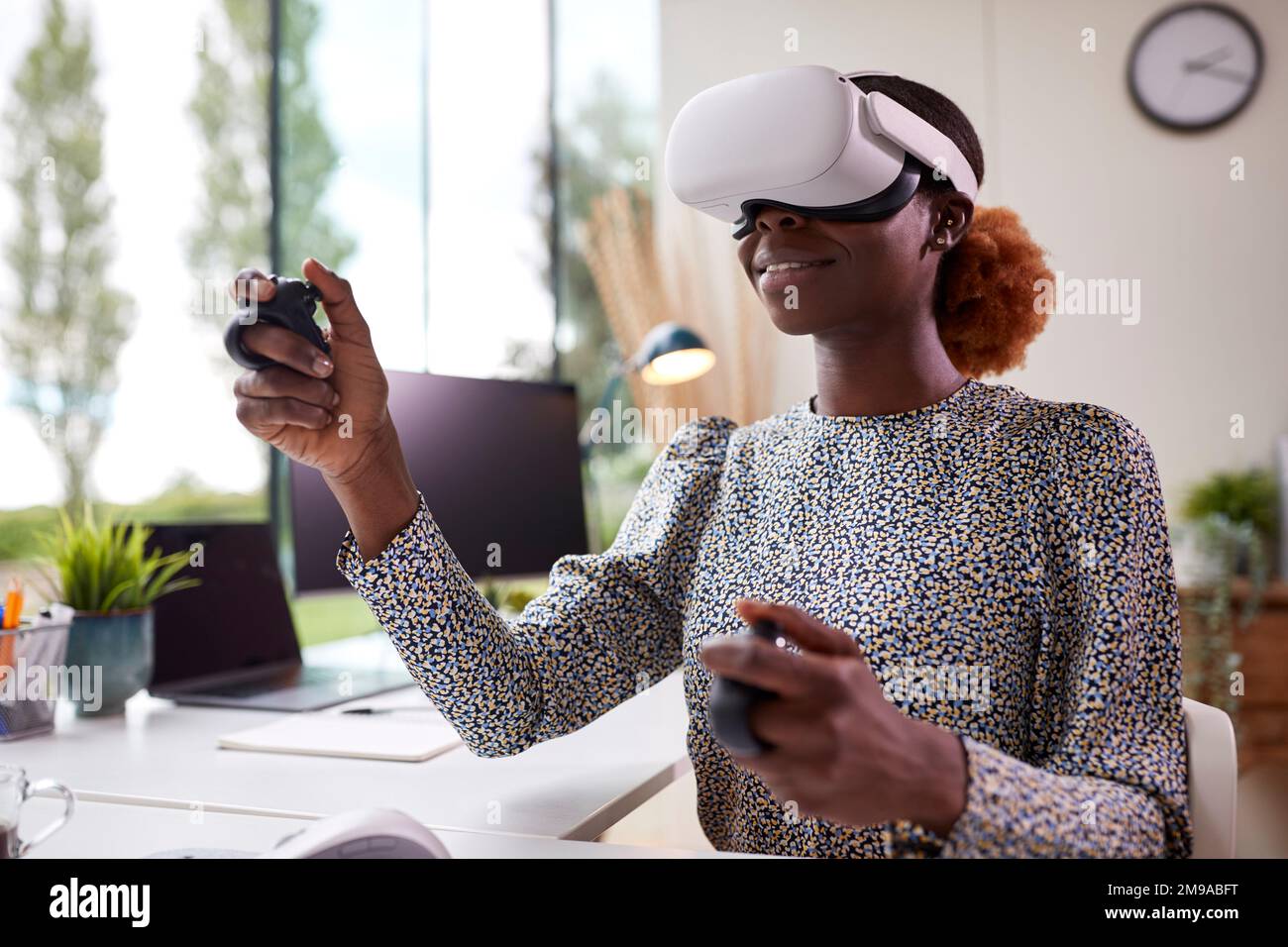 Woman Working From Home Office With Controllers Wearing VR Headset ...