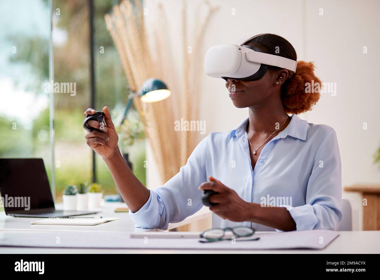 Woman Working From Home Office With Controllers Wearing VR Headset ...