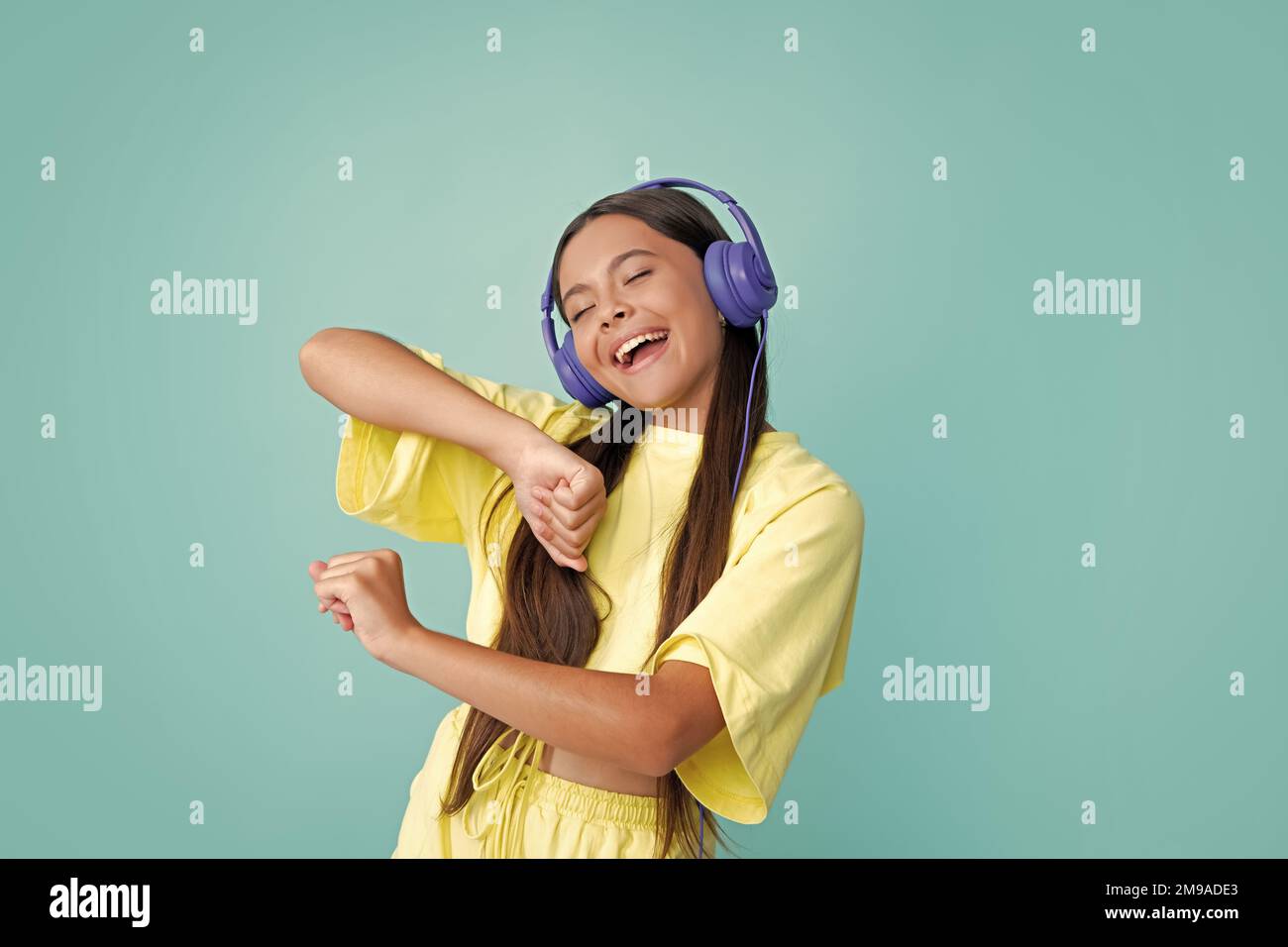 Child listening music with headphones. Girl listening songs via ...
