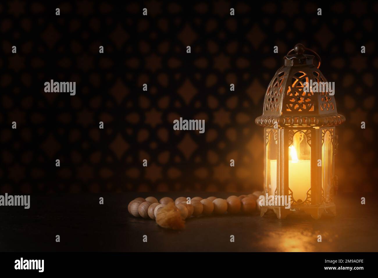 Muslim lamp and tasbih on dark background with space for text Stock ...