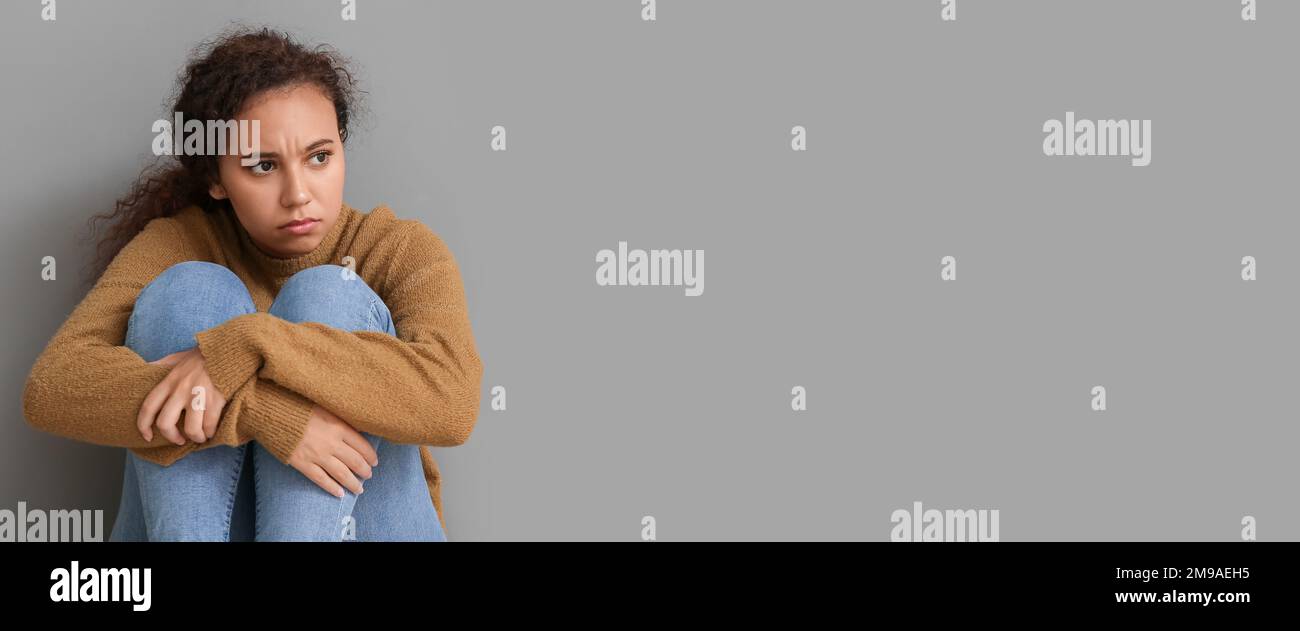 Sad African-American woman on grey background with space for text. Stop ...