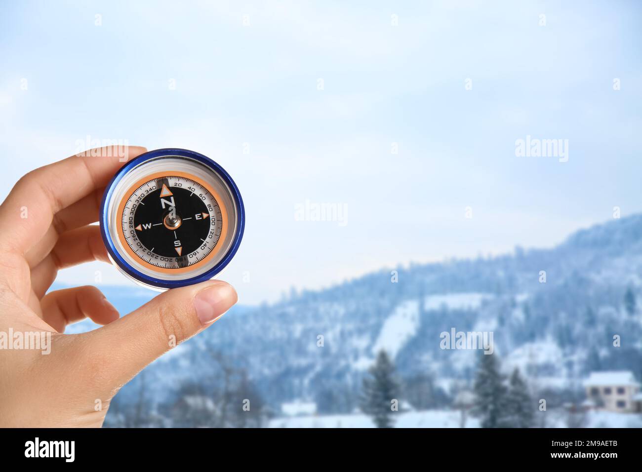 Human hand with compass at winter resort Stock Photo - Alamy