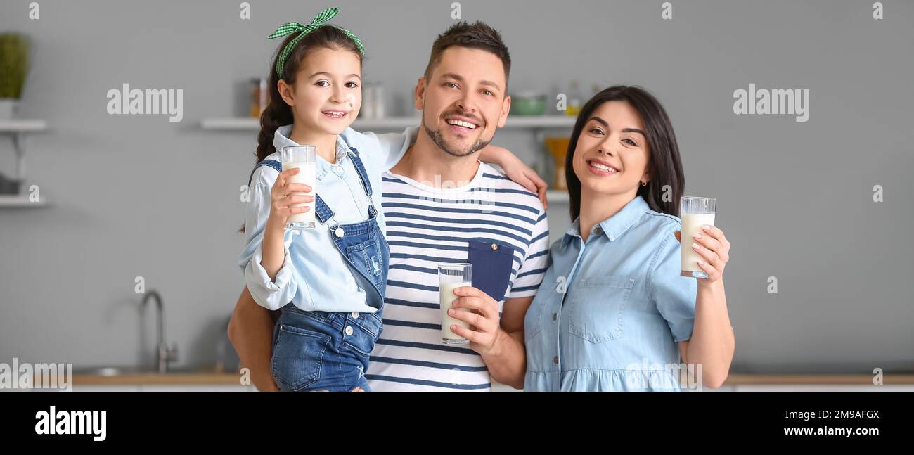 Happy family drinking milk at home Stock Photo - Alamy