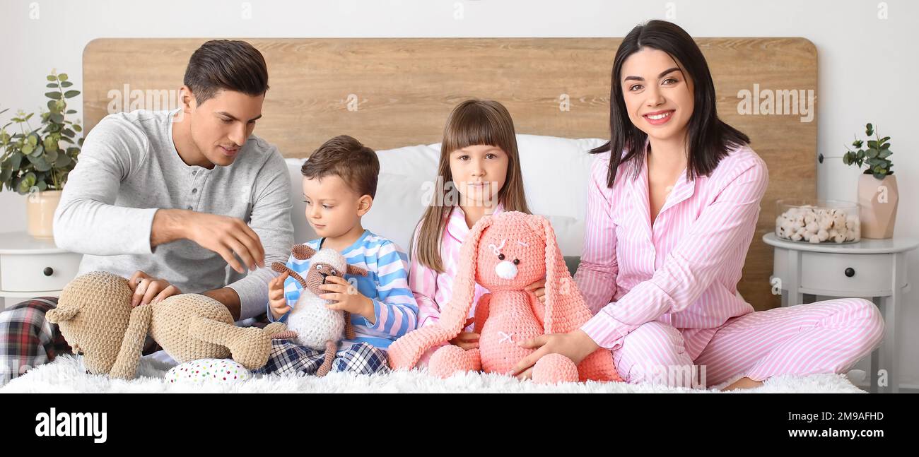 Happy family in pajamas in bedroom at home Stock Photo - Alamy