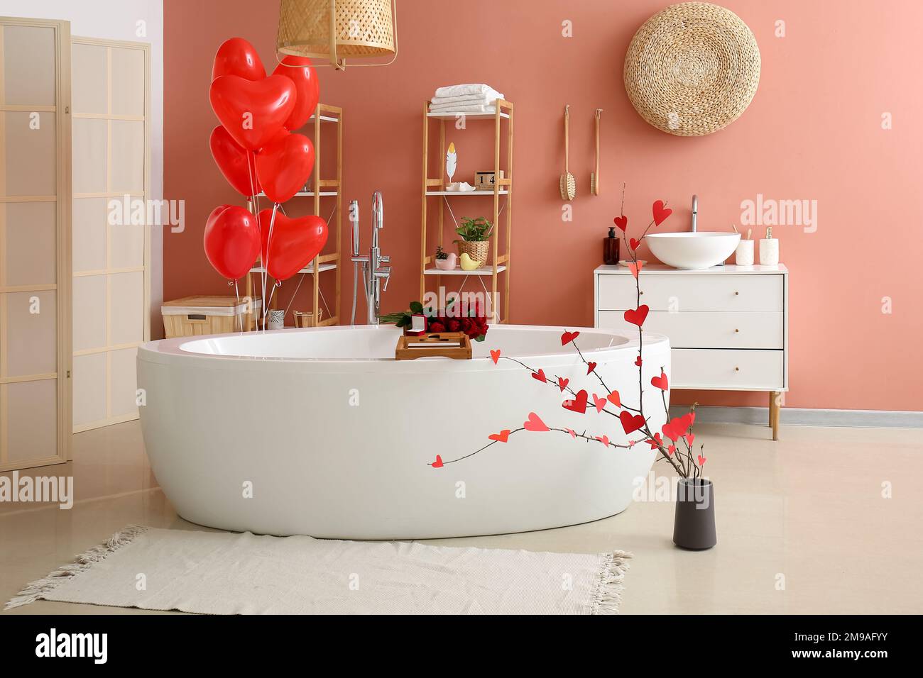 Interior of bathroom decorated for Valentine's Day with bathtub, roses ...