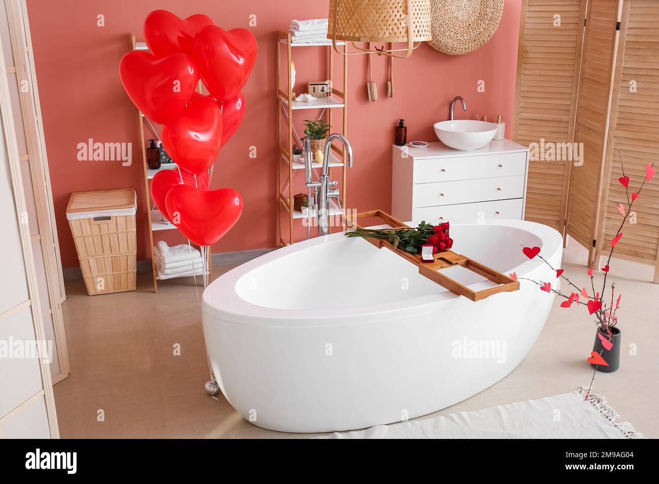 Interior of bathroom decorated for Valentine's Day with bathtub, roses ...