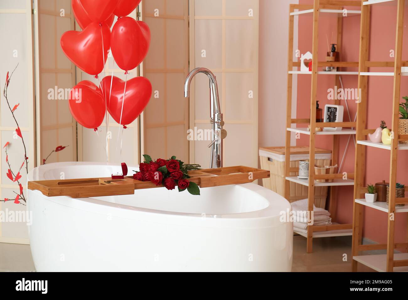Interior of bathroom decorated for Valentine's Day with bathtub, roses ...