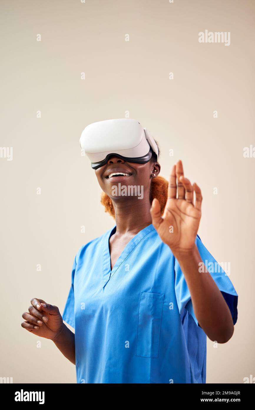 Female Nurse Or Doctor In Scrubs With VR Headset Interacting With AR ...