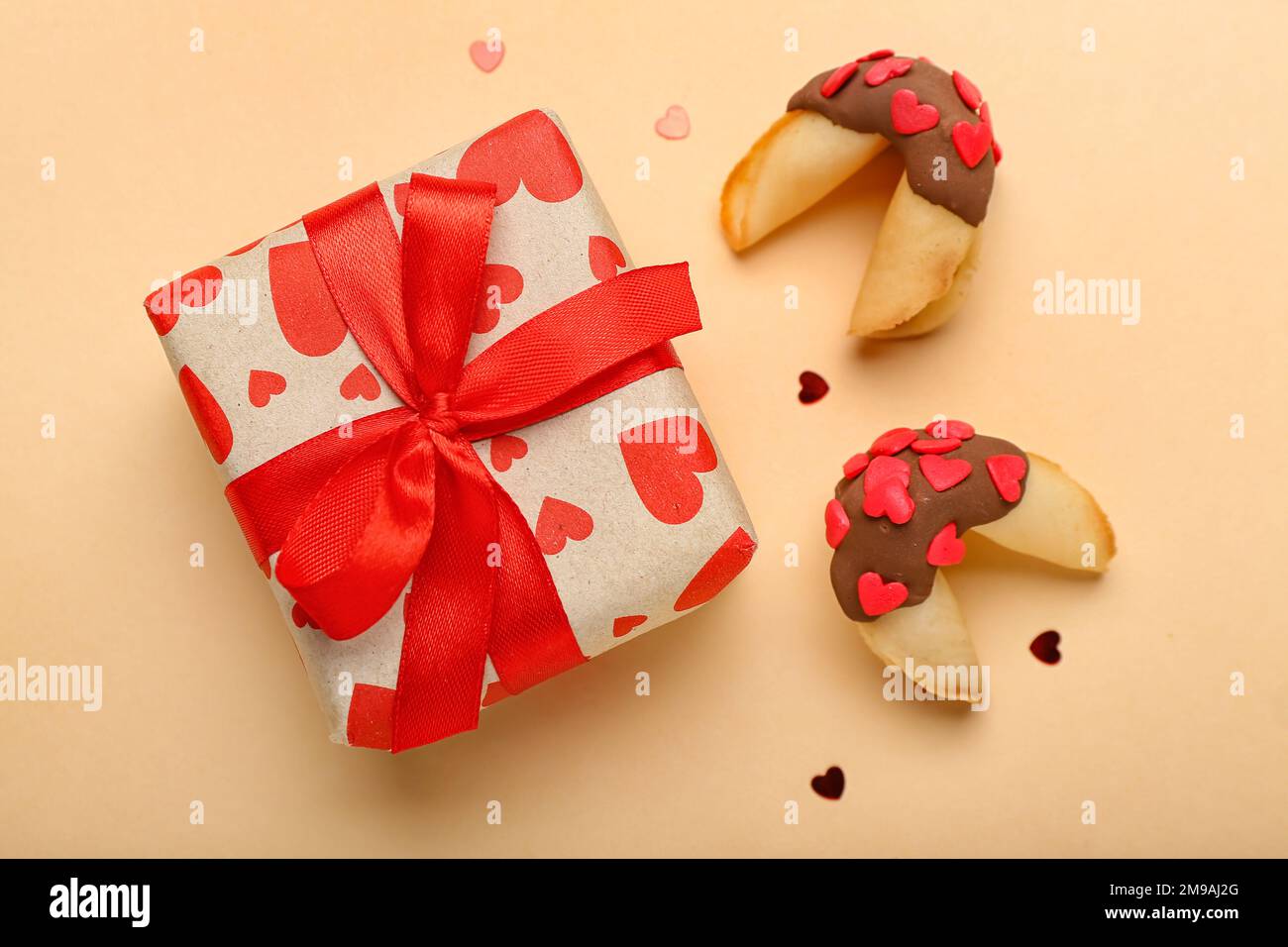 Fortune cookies with gift on beige background. Valentine's Day ...