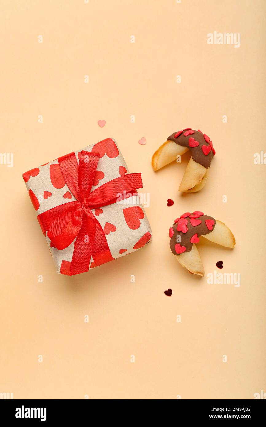 Fortune cookies with gift on beige background. Valentine's Day ...