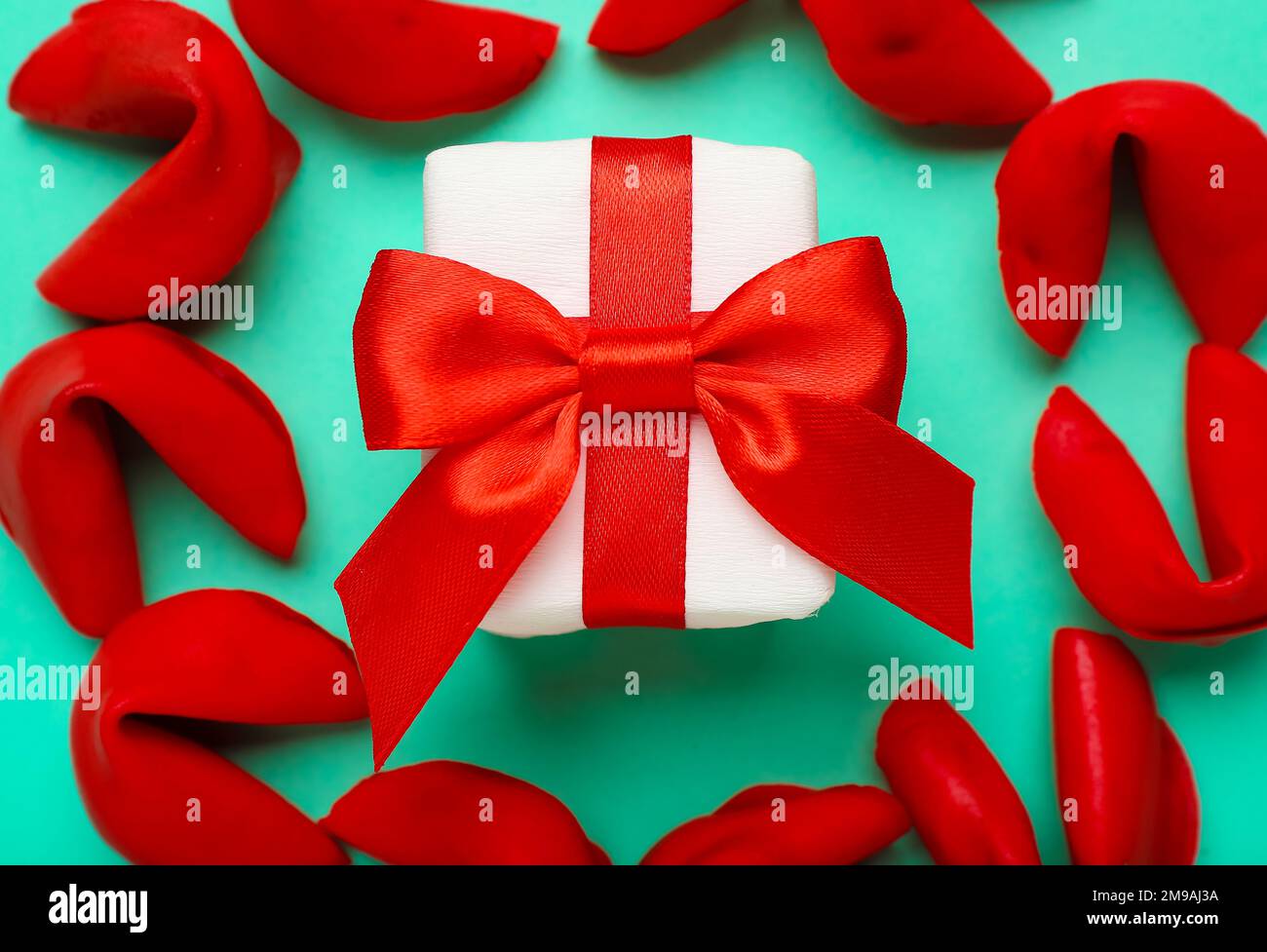 Red fortune cookies with gift on green background, closeup. Valentine's ...
