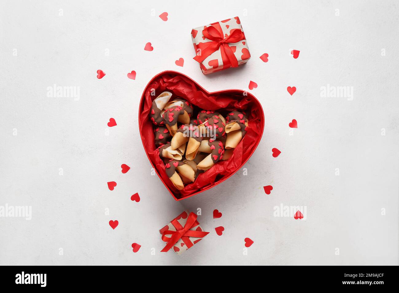 Box with fortune cookies, gifts and hearts on white background ...