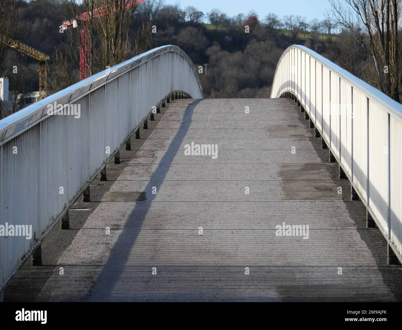 Perspective view of a curved pedestrian bridge with steel railing for ...