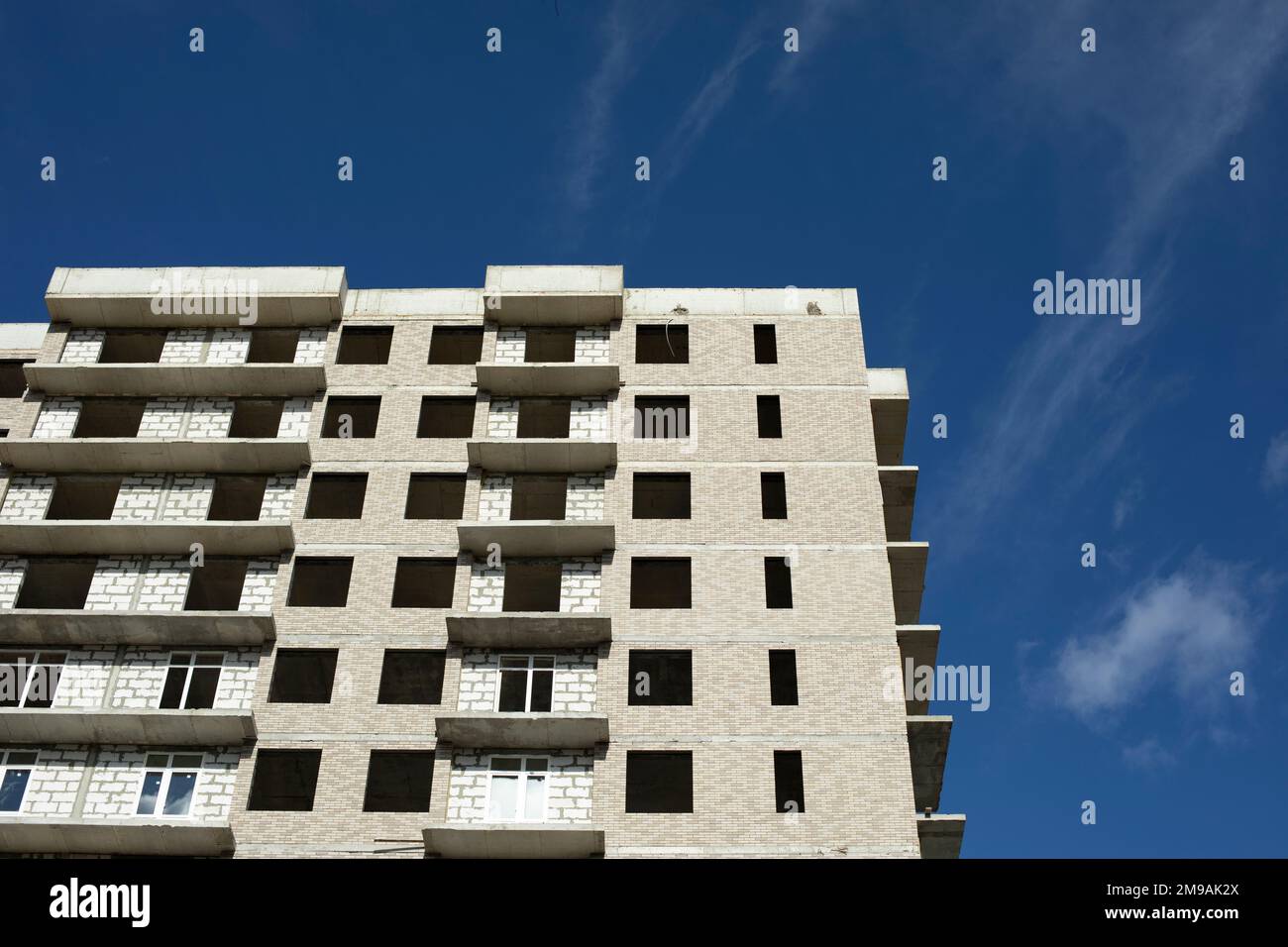 New building. Empty windows in house. Concrete blocks. Buildings in ...