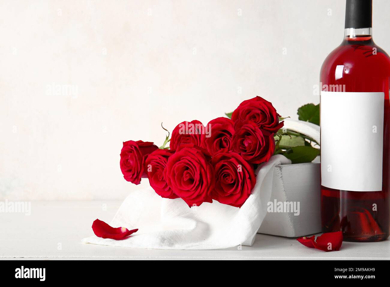 Bottle of wine and rose flowers on white background. Valentine's Day ...