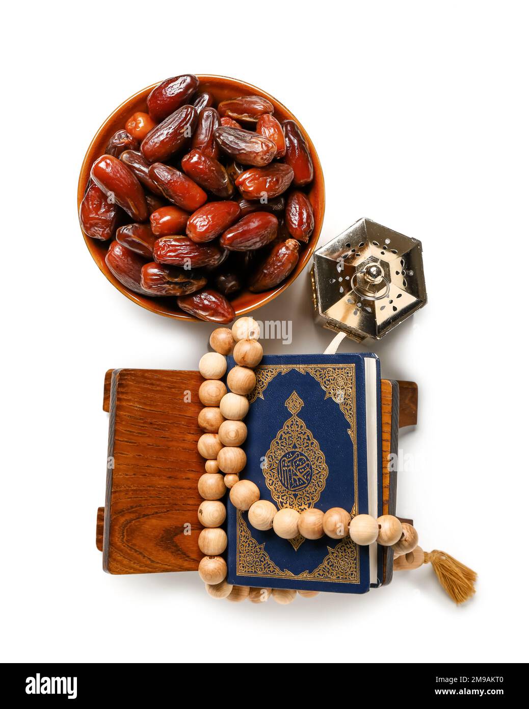 Bowl of dates, prayer beads, Koran and Muslim lantern for Ramadan on ...
