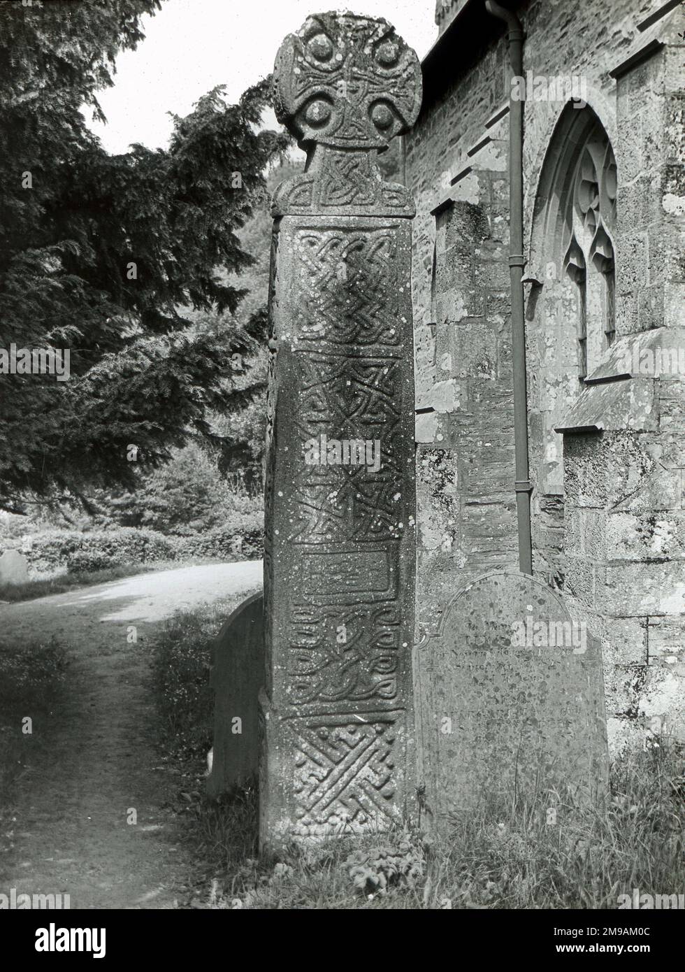 A 10th century Celtic cross in the churchyard of the Norman Church of ...
