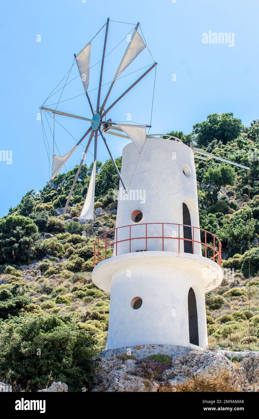 A vertical shot of a traditional greek white windmill Stock Photo - Alamy