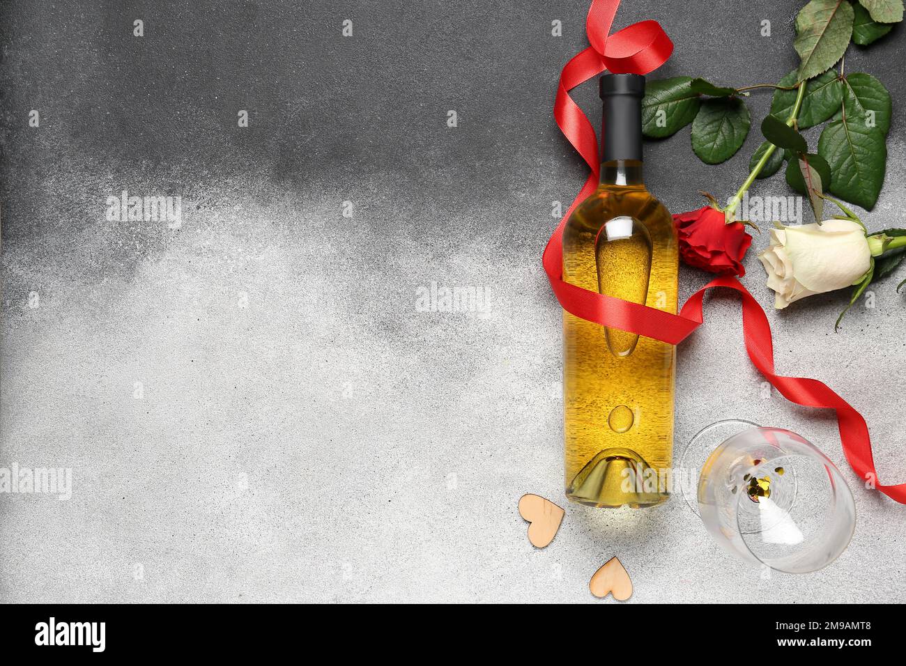 Bottle of wine, ribbon and rose flowers on grunge background. Valentine ...