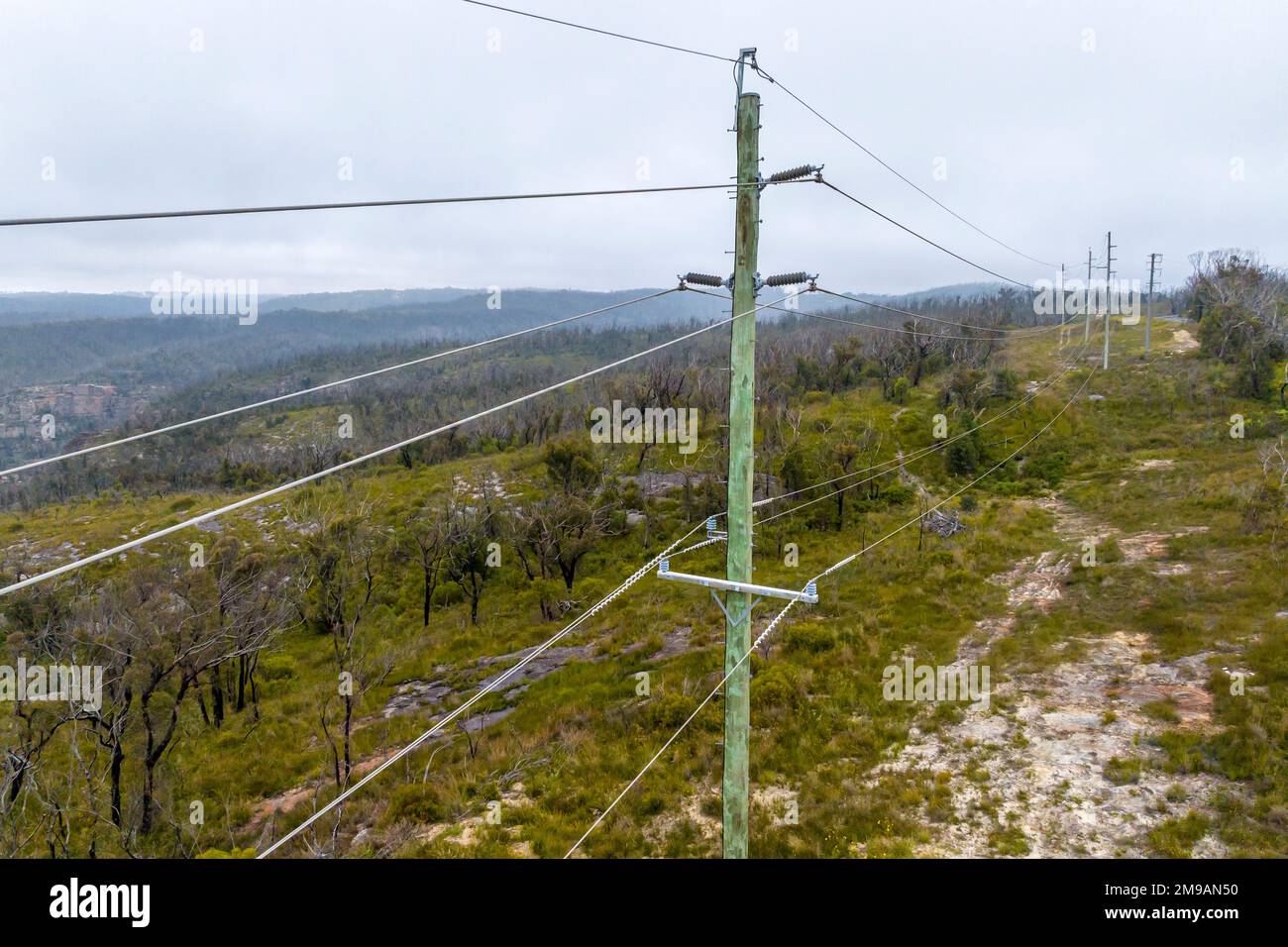 Drone aerial photograph of a green wooden powerline pole with a ...