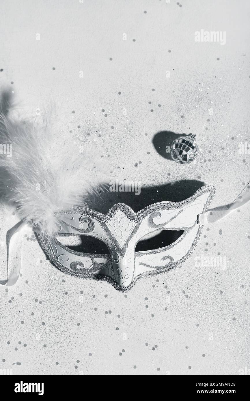 Carnival mask with ball and confetti on light background Stock Photo ...