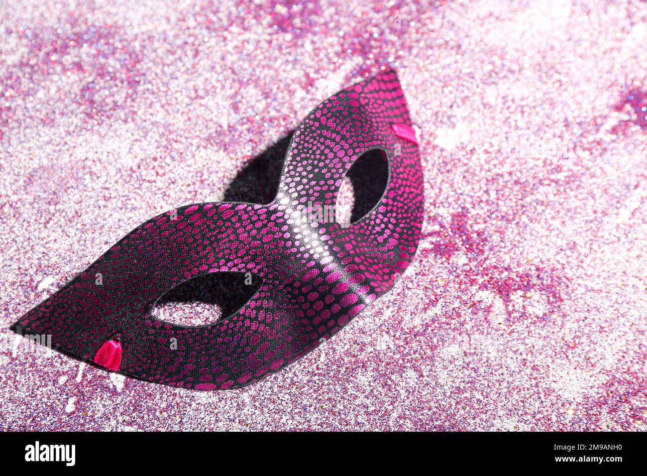 Carnival mask and glitter on light background Stock Photo - Alamy