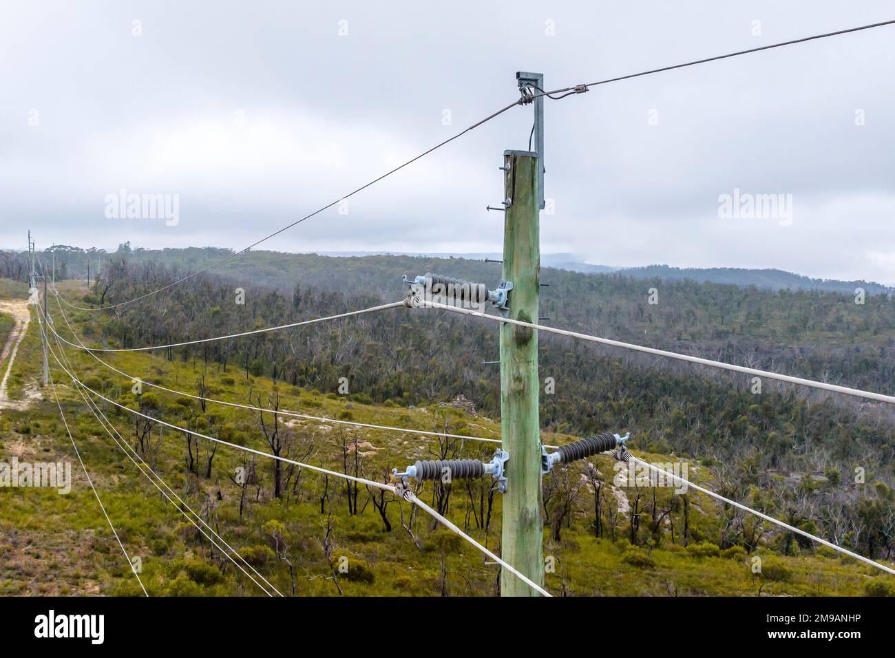 Drone aerial photograph of a green wooden powerline pole with a ...