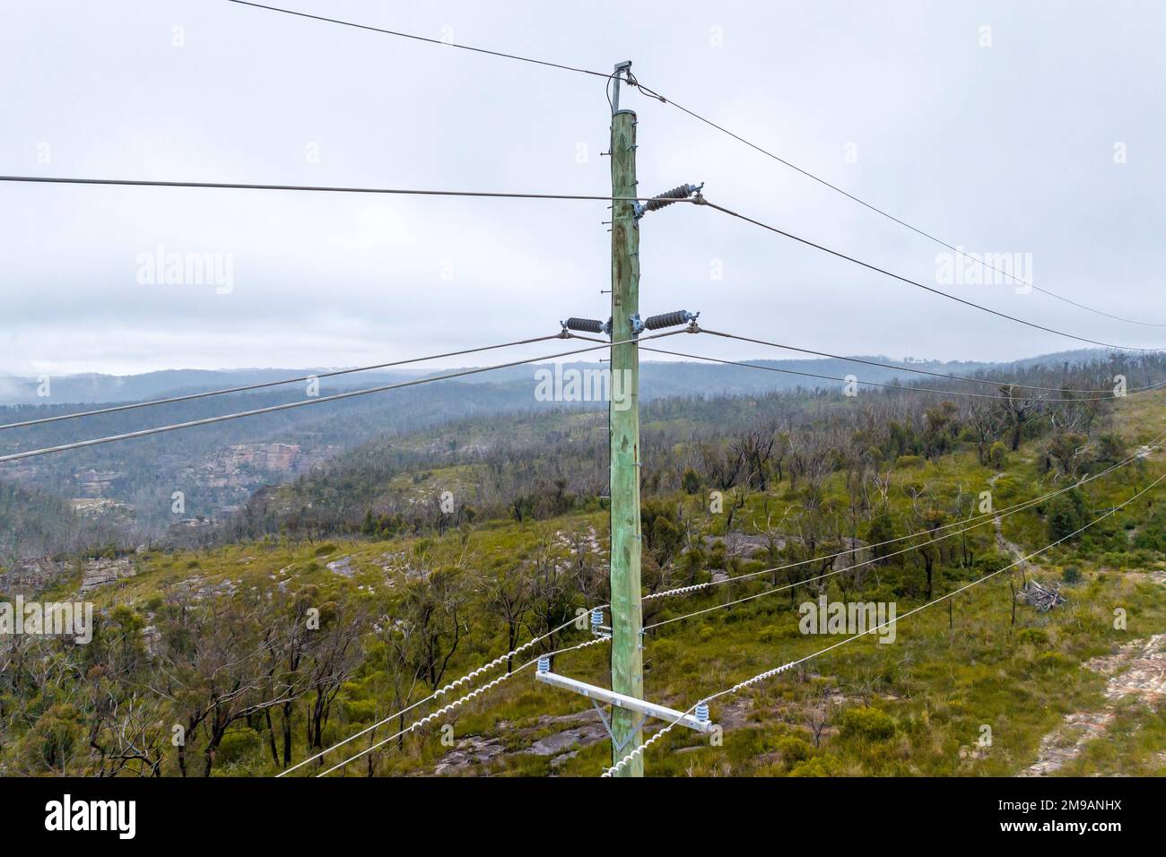Drone aerial photograph of a green wooden powerline pole with a ...
