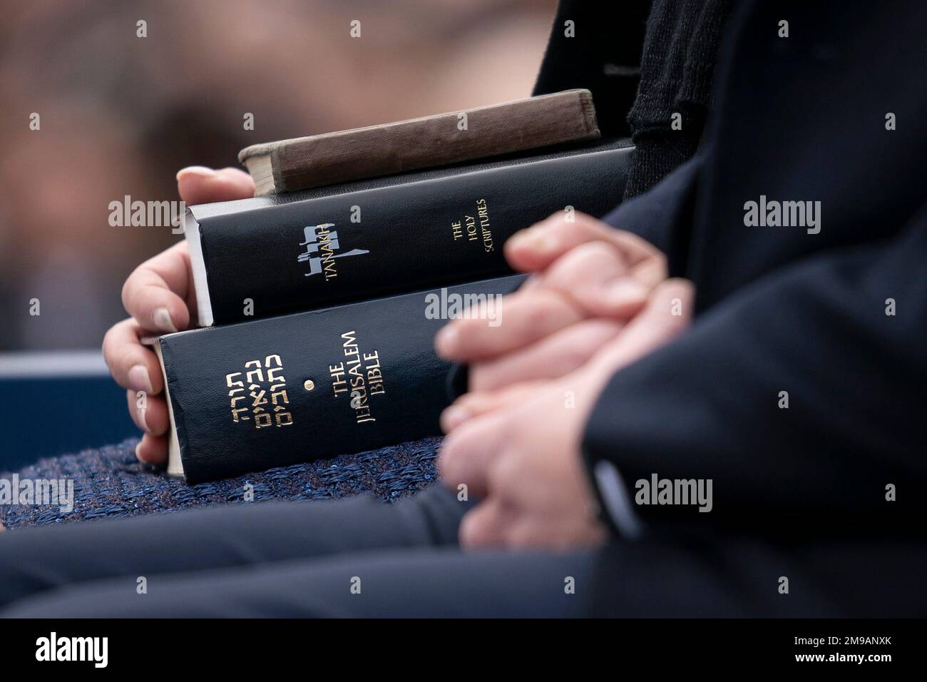 Lori Shapiro, holds three Hebrew Bibles before her husband Josh Shapiro ...