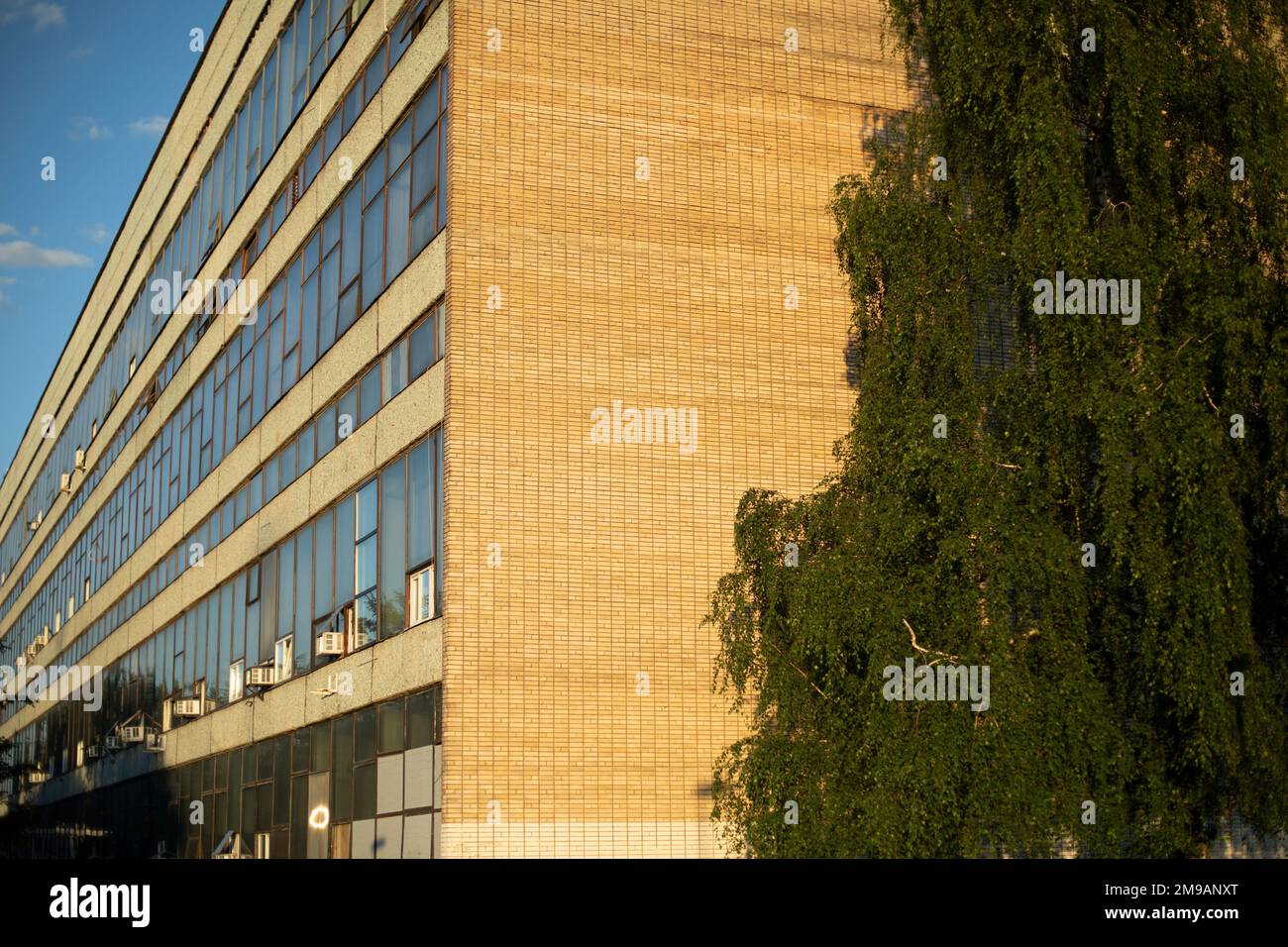 Old building of brick and glass. Long industrial building in city. View ...
