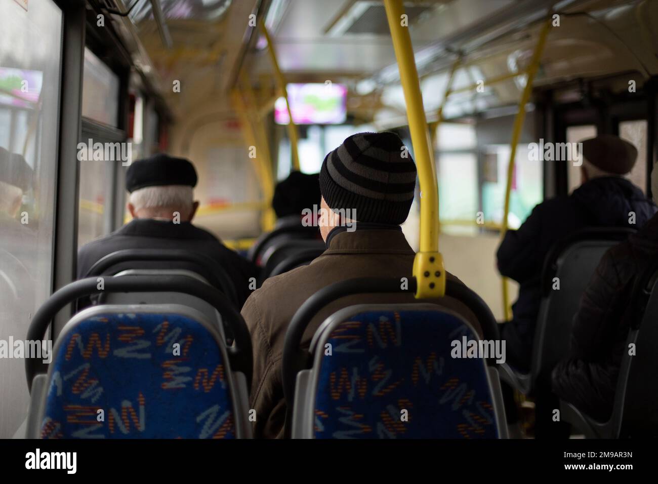 People on bus. Seating on public transport. Seats in interior of bus ...
