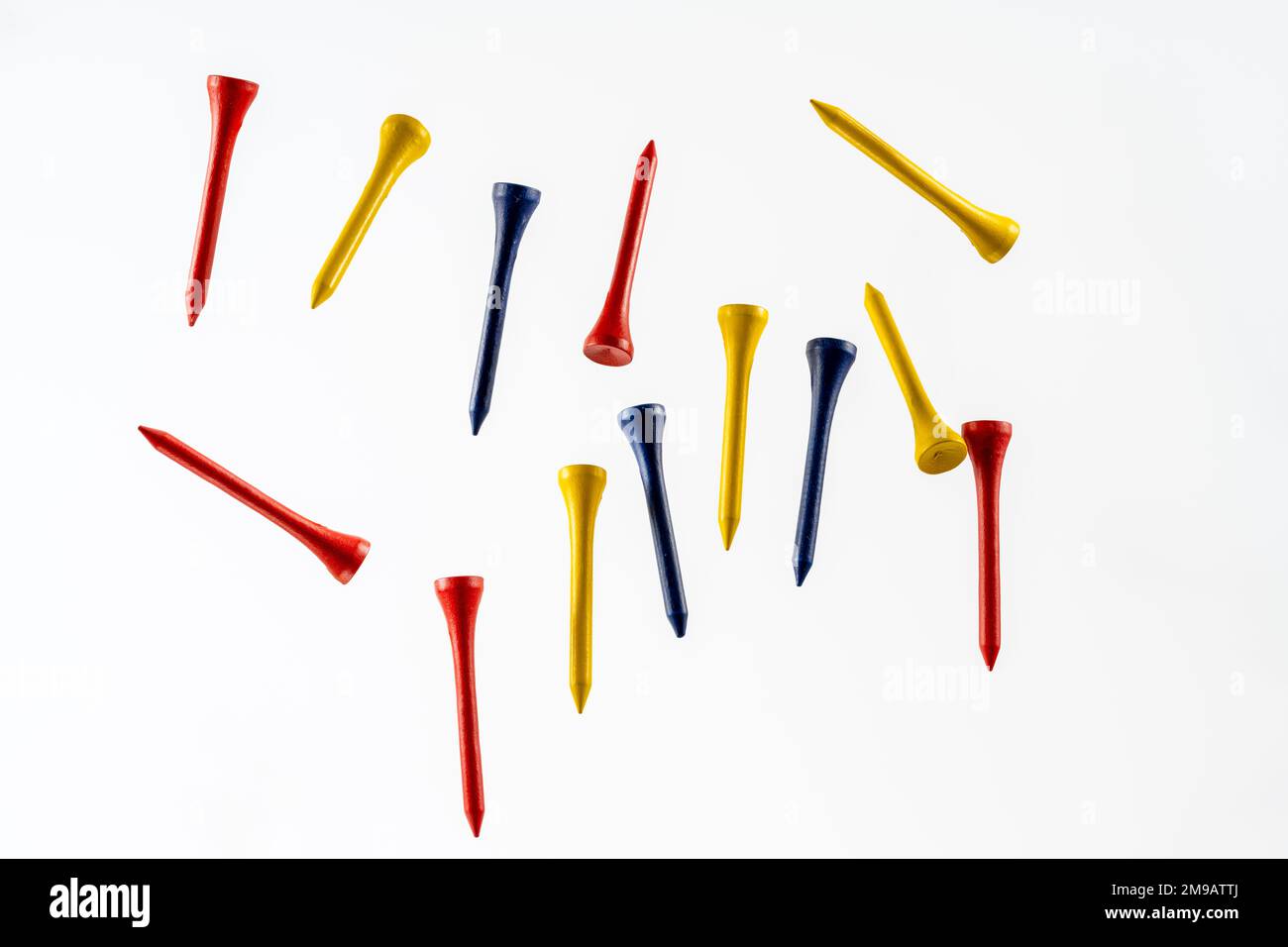 color wooden bamboo golf tees fallnig through the air isolated on a ...