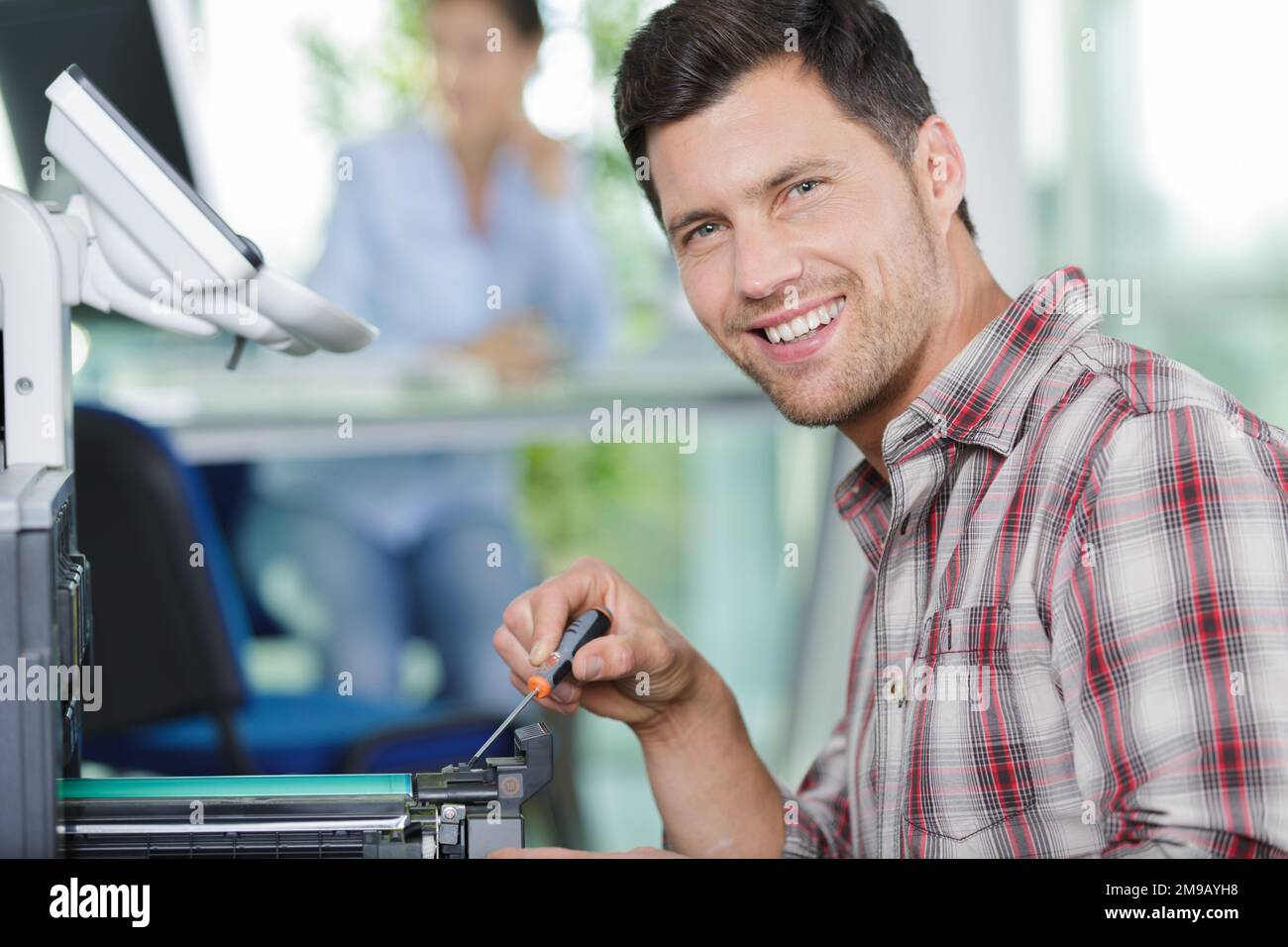 hardware repairman repairing broken printer fax machine Stock Photo - Alamy