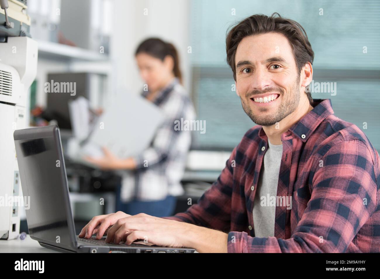 man in an office using a computer Stock Photo - Alamy