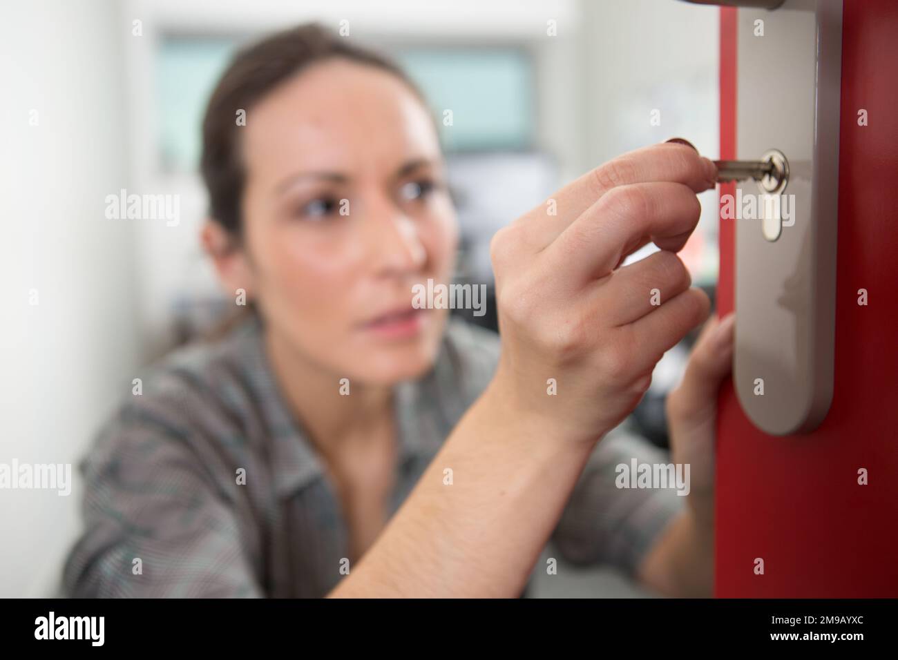 lady entering key into lock Stock Photo - Alamy