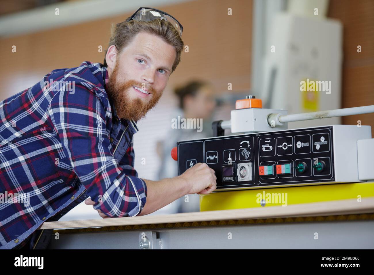 a happy man operating machine Stock Photo - Alamy