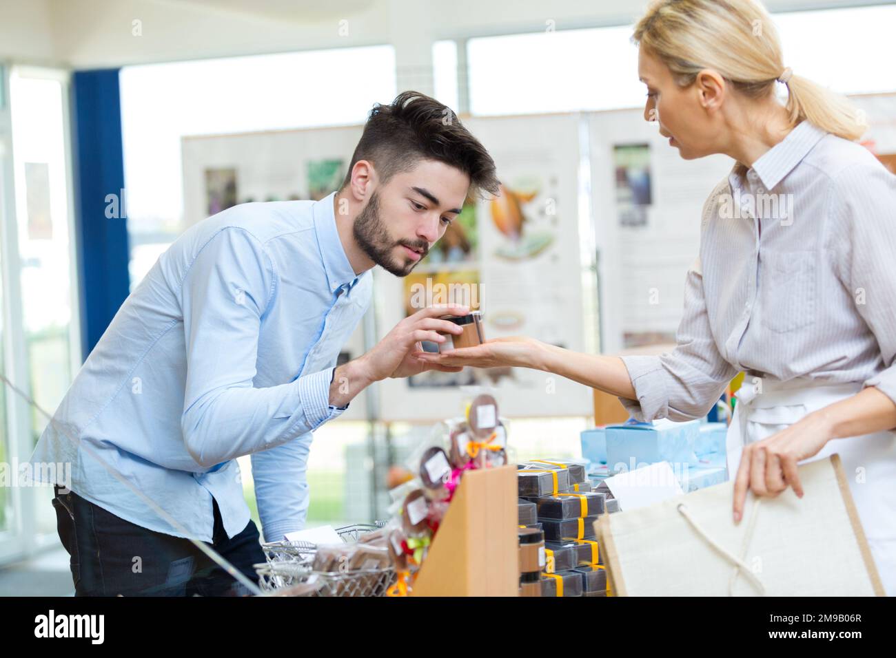 customer examining product held in retailers hand Stock Photo - Alamy