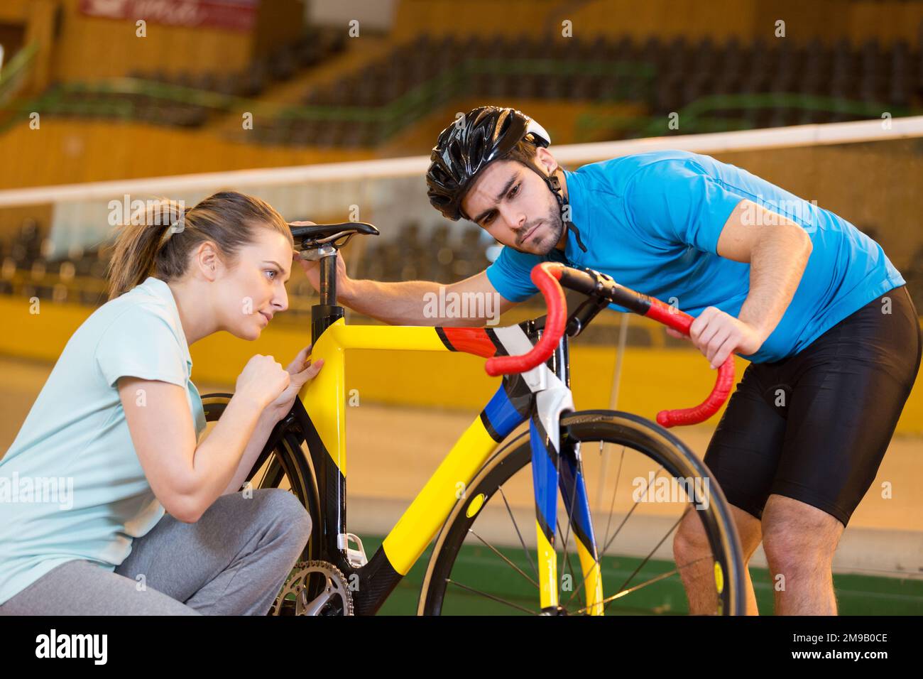 female coach speaking with cyclist on velodrome track Stock Photo - Alamy