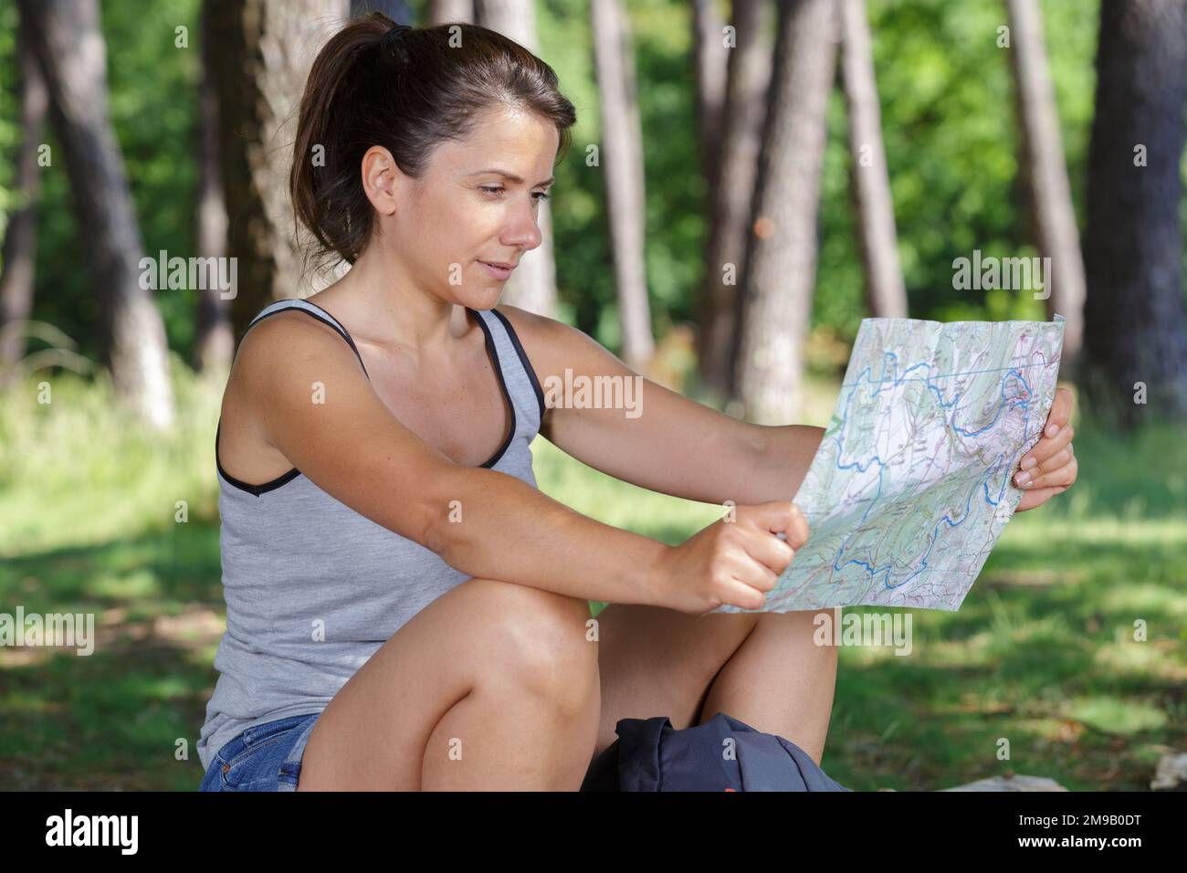female hiker reading her map Stock Photo - Alamy