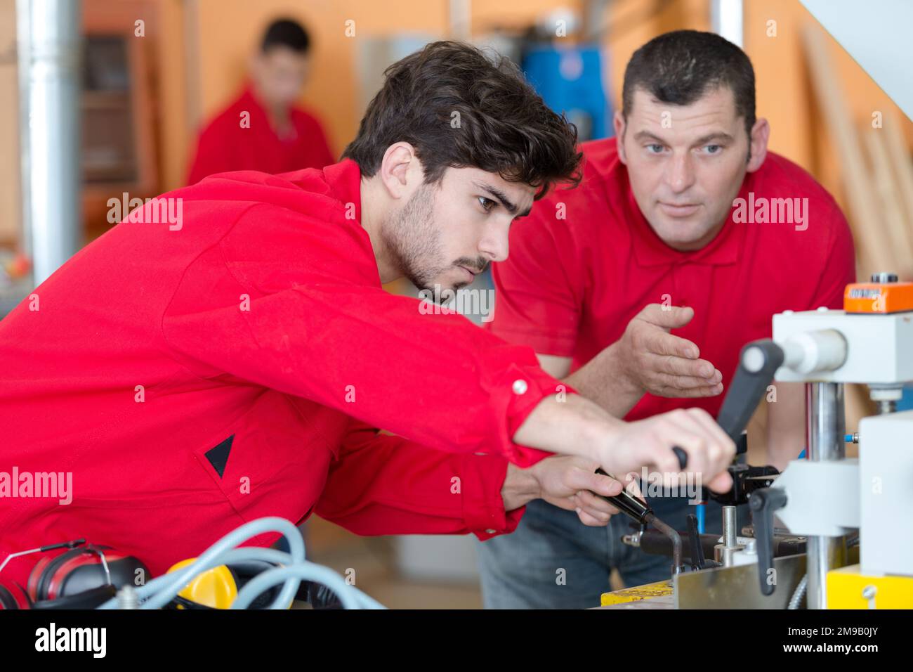 two men doing factory work Stock Photo - Alamy
