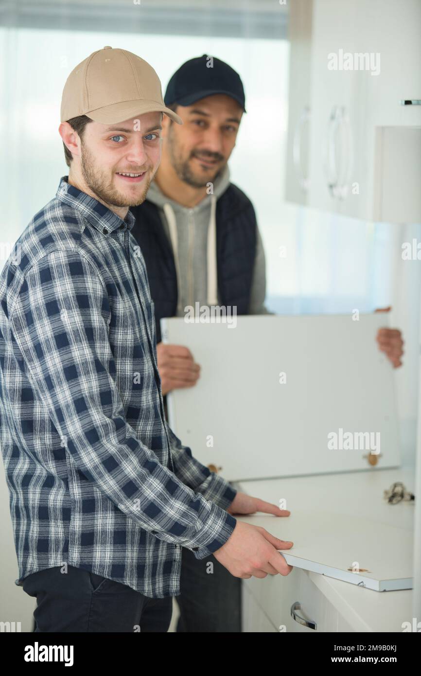 Two men fixing in kitchen hi-res stock photography and images - Alamy