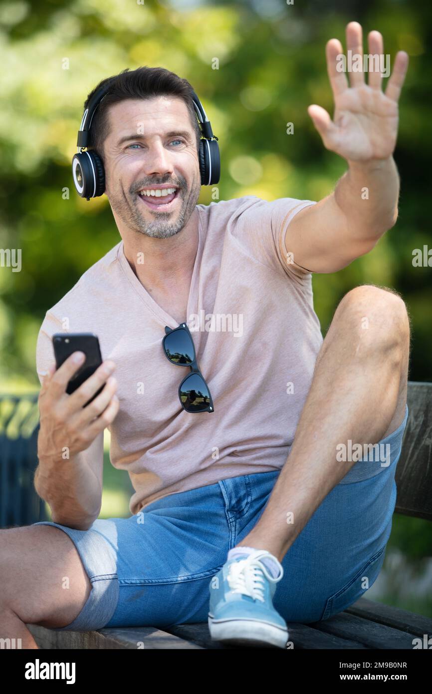Young smiling guy waving hi-res stock photography and images - Alamy