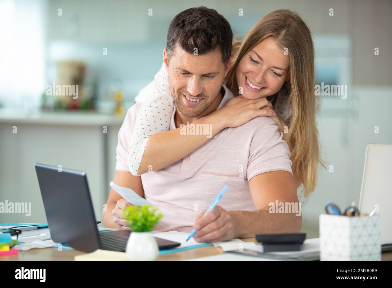 romantic couple using computer and making notes Stock Photo - Alamy