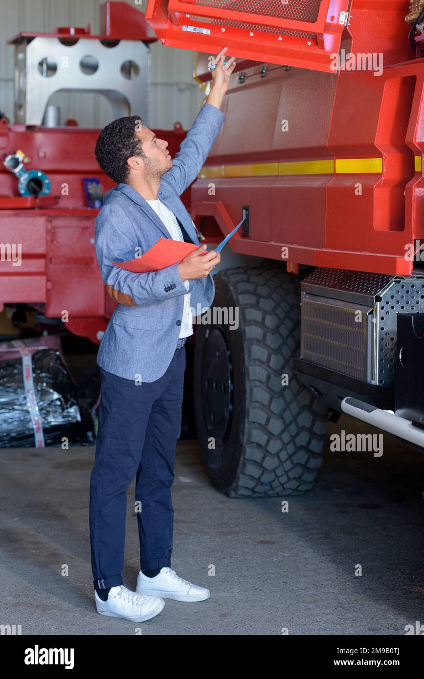 a male supervising firefighter lorry Stock Photo - Alamy
