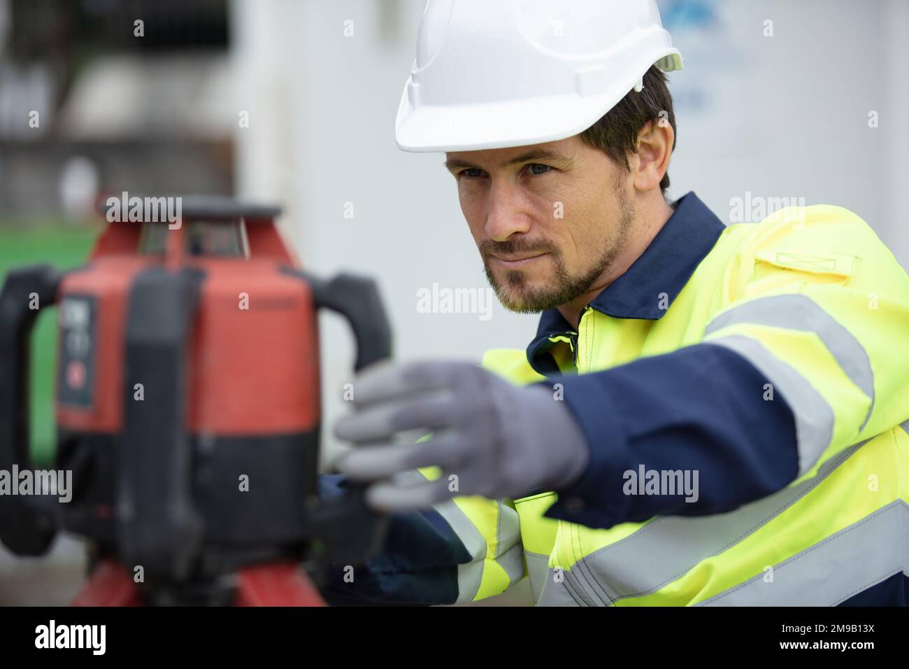 construction man worker measuring construction site Stock Photo - Alamy